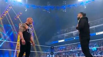 WWE: 'The Rock' Dwayne Johnson, Roman Reigns in a dramatic staredown on ...